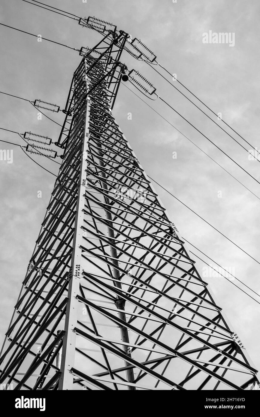 Bottom view of power line pole in black and white Stock Photo - Alamy