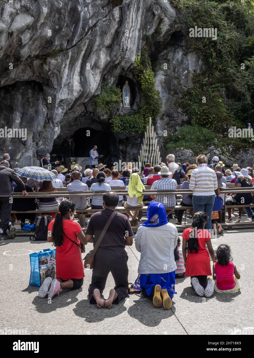 Lourdes, France - August 28, 2021: Pilgrims praying in front of the ...