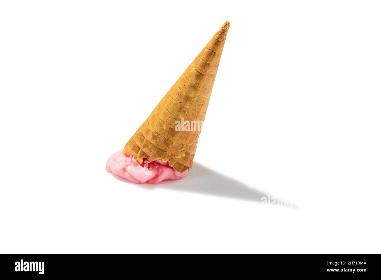 Upturned crisp waffle ice-cream cone with shadow isolated on white ...