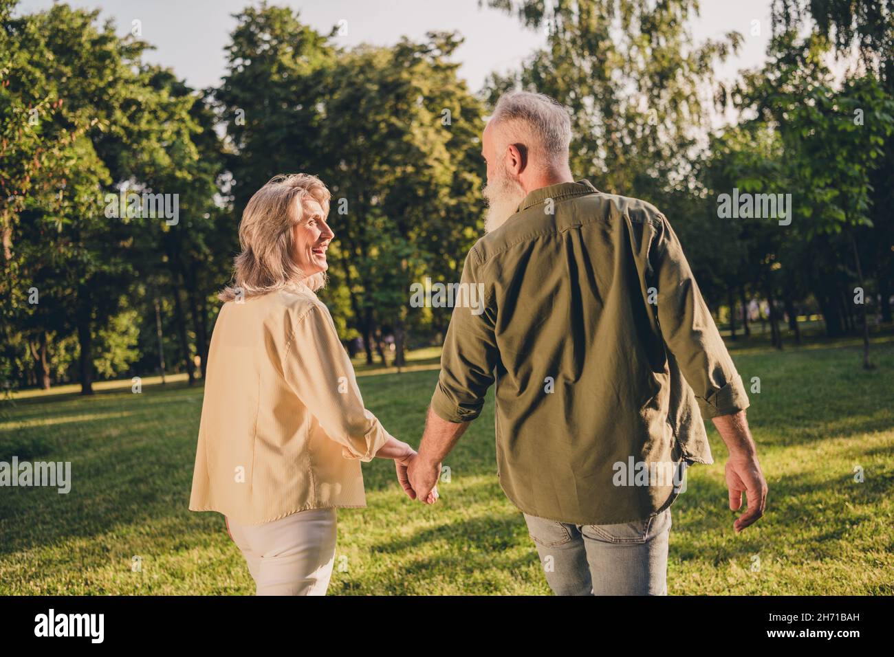 Rear back behind view portrait of attractive cheerful middle-aged ...