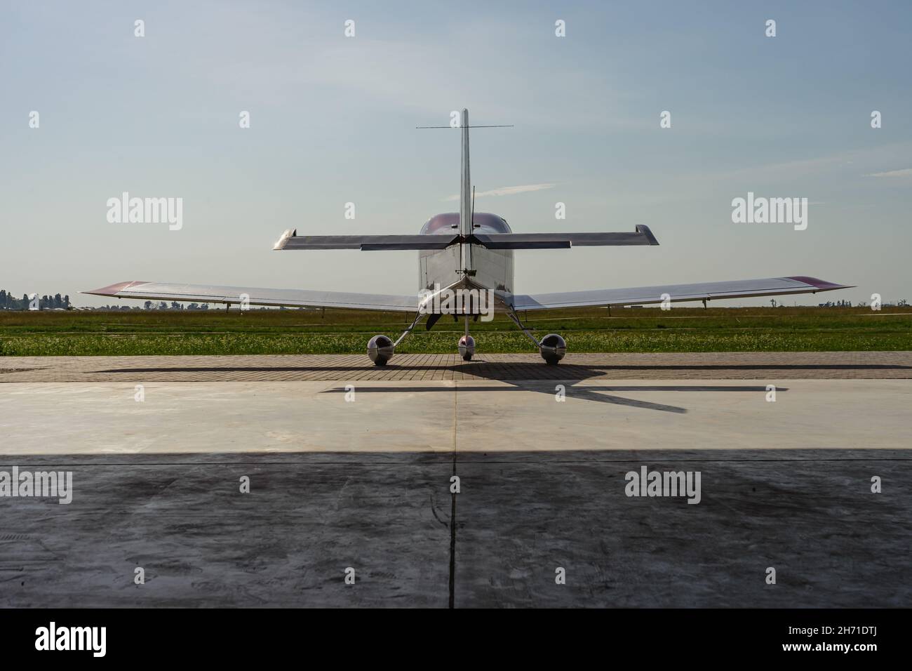 A small private jet on the landing site before takeoff. Back view Stock ...
