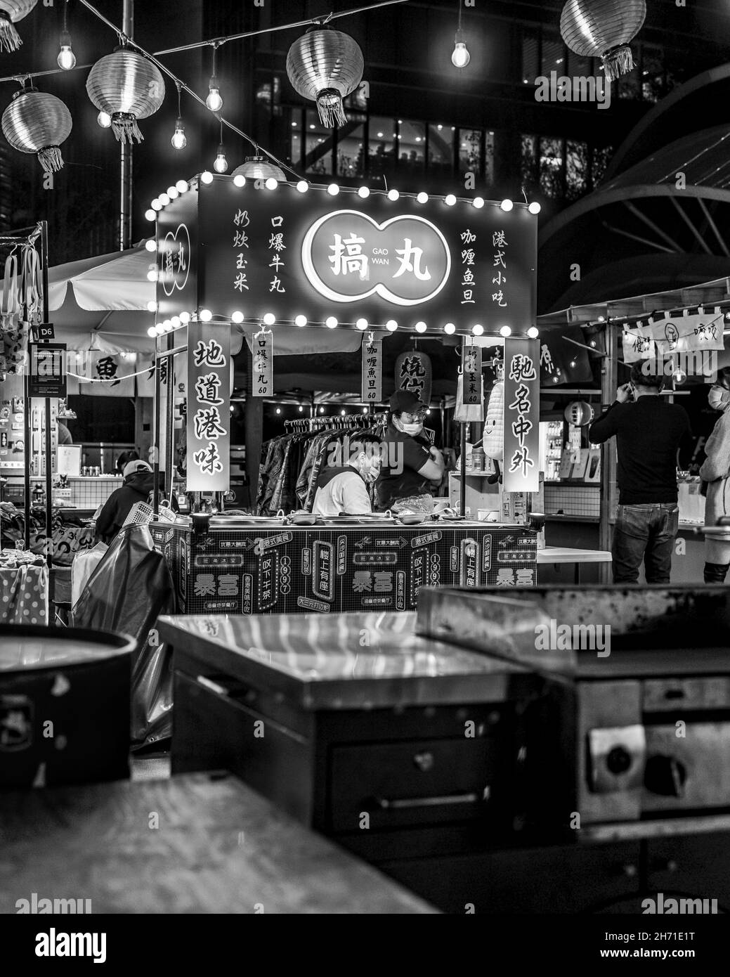 TAICHUNG, TAIWAN - Oct 20, 2021: A vertical grayscale shot of street ...