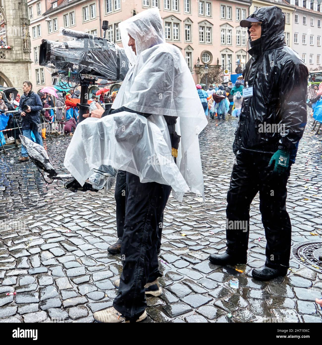 Braunschweig, Germany, February 23, 2020: TV crew in rain gear with ...