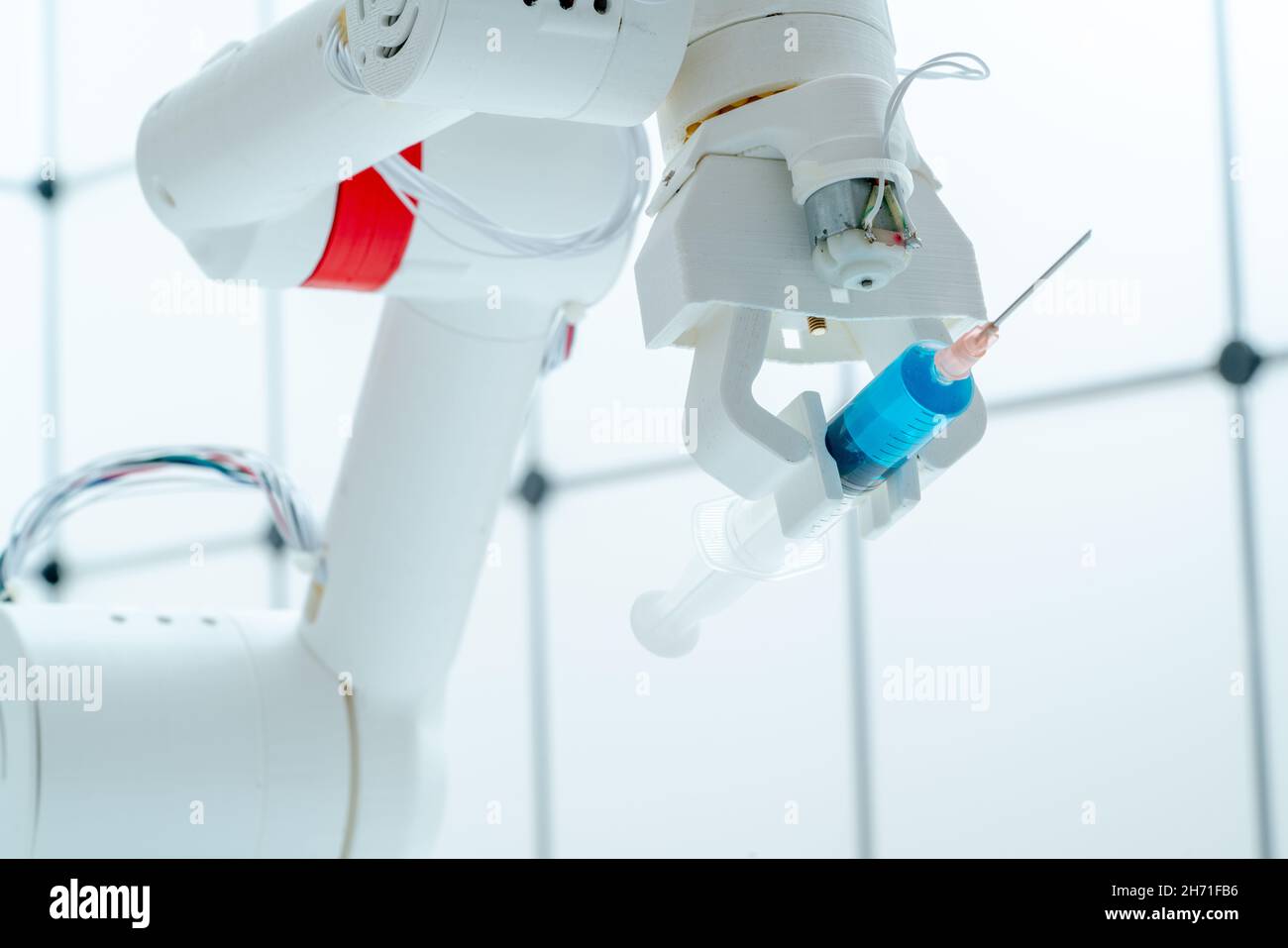 Robot hand with a medical syringe. Future medicine concept using robots ...