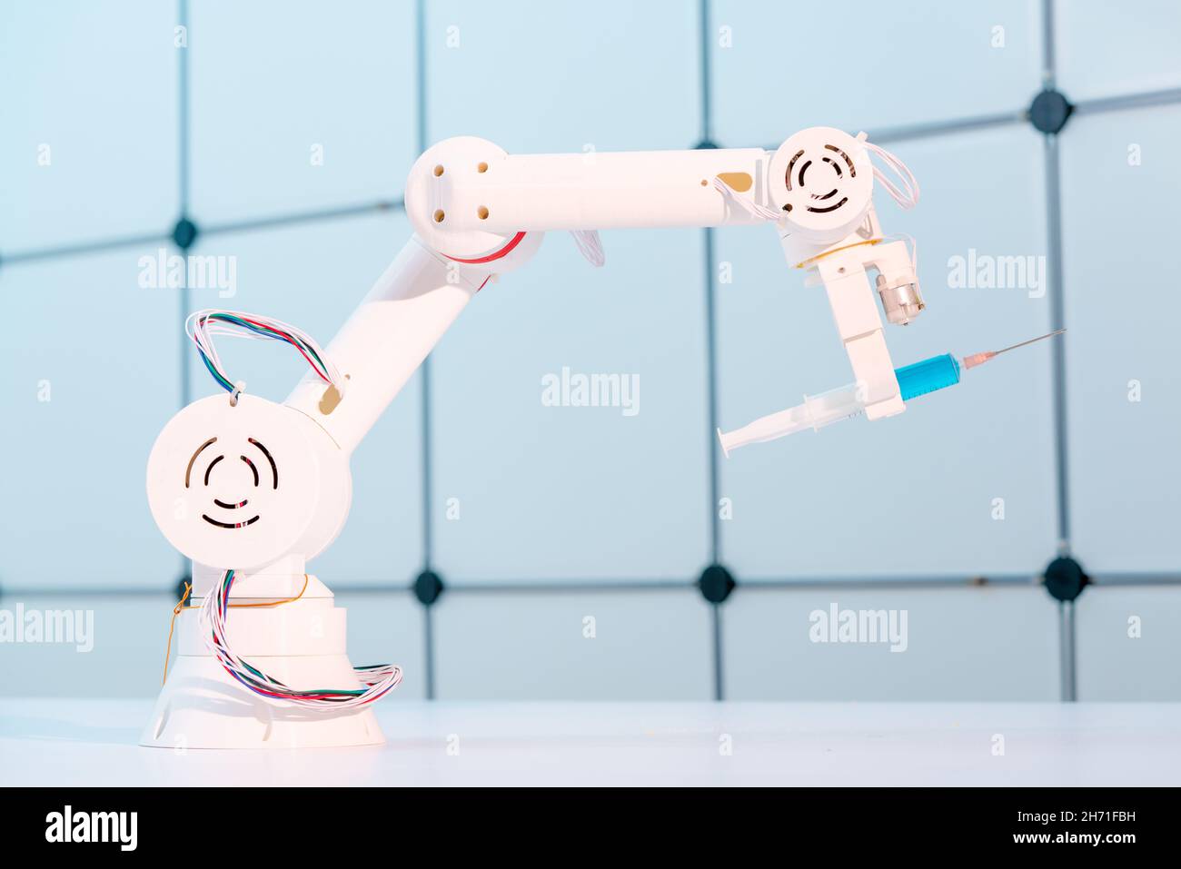 Robot hand with a medical syringe. Future medicine concept using robots ...