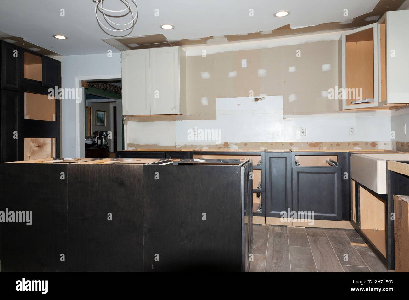 A residential kitchen under constuctiion with new cabinets and floors ...