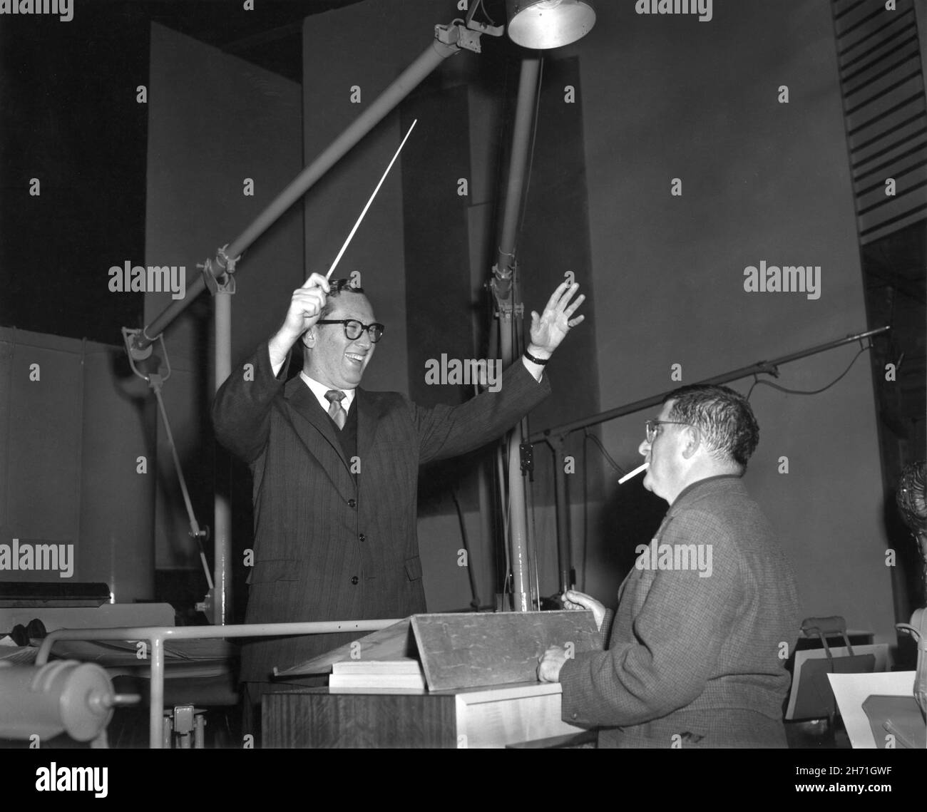 Producer CHARLES H. SCHNEER (pretending to conduct) and Film Composer ...
