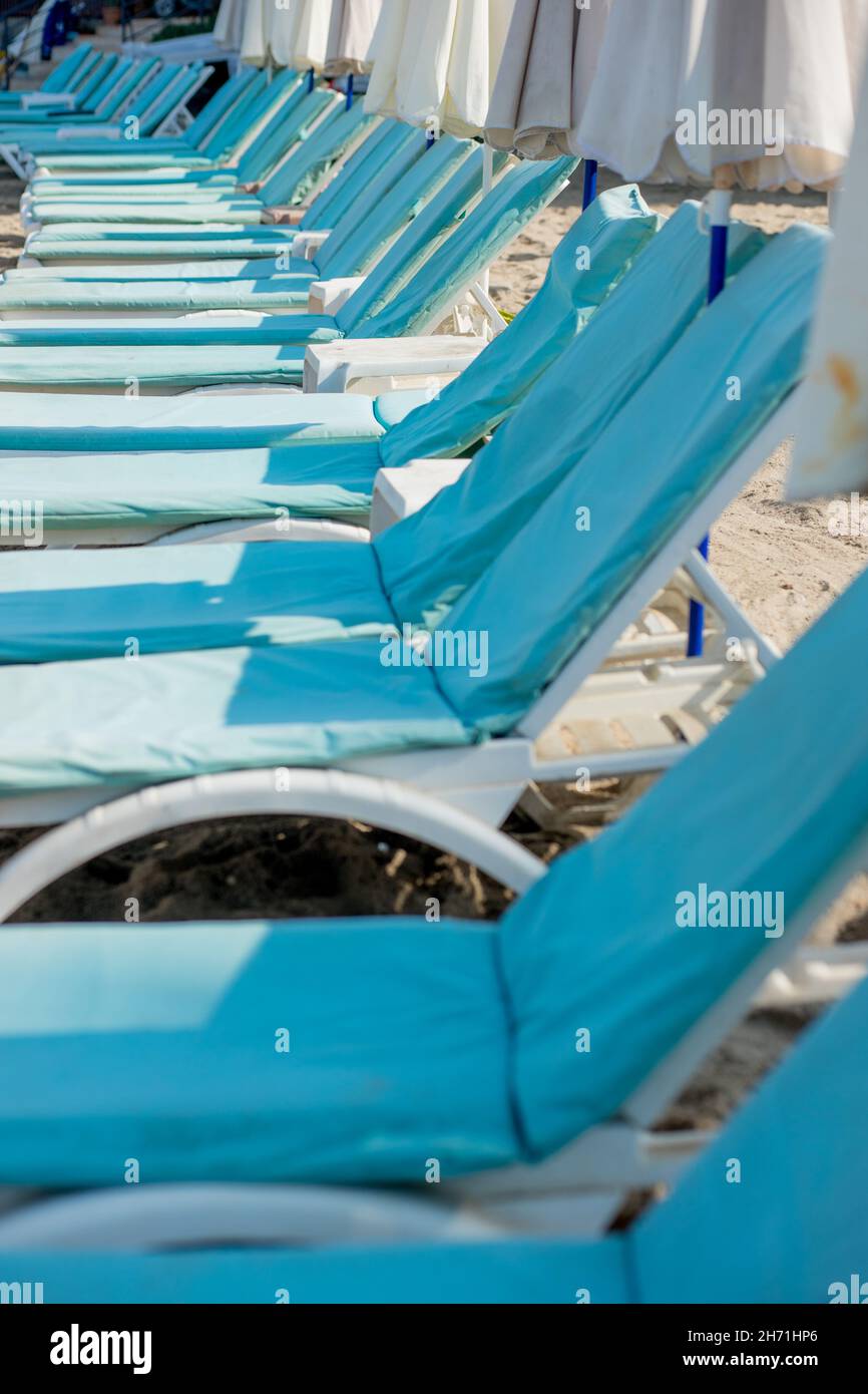 Empty blue sunbeds on a modern beach Stock Photo - Alamy