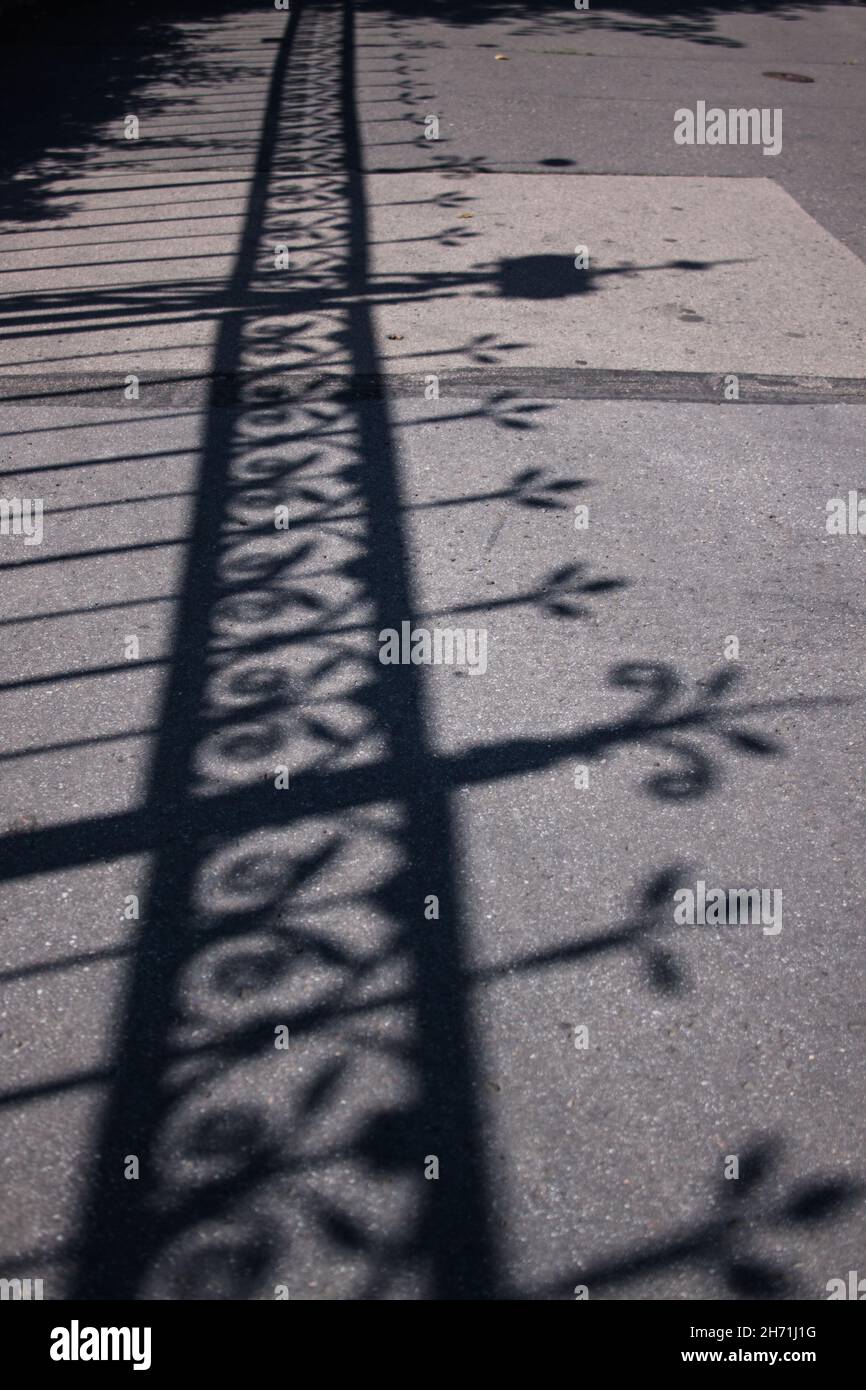 Metal fence cast shadow on sidewalk in the street of Budapest Hungary ...