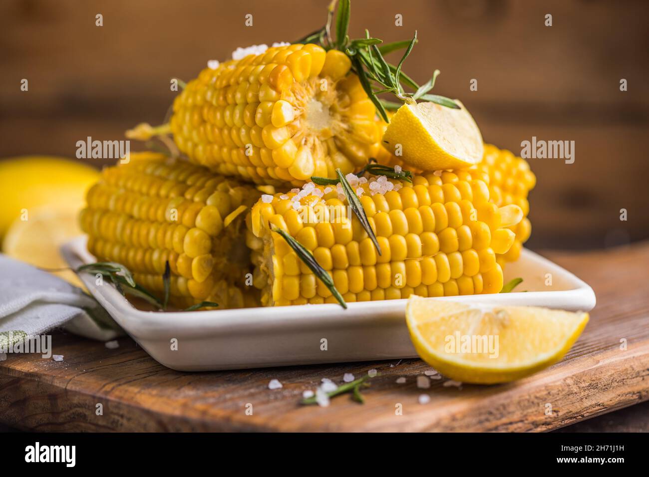 Delicious Mexican boiled corn cobs with sea salt and lime serving board ...