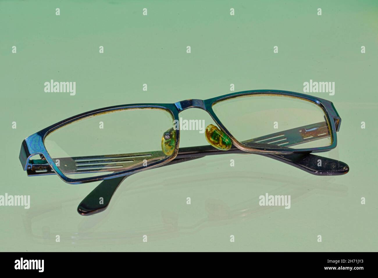 Reflection of eyeglasses. Blue eyeglasses, close-up. Eye glasses. Old ...