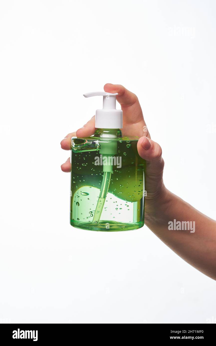Female hands using hand sanitizer over white background Stock Photo - Alamy