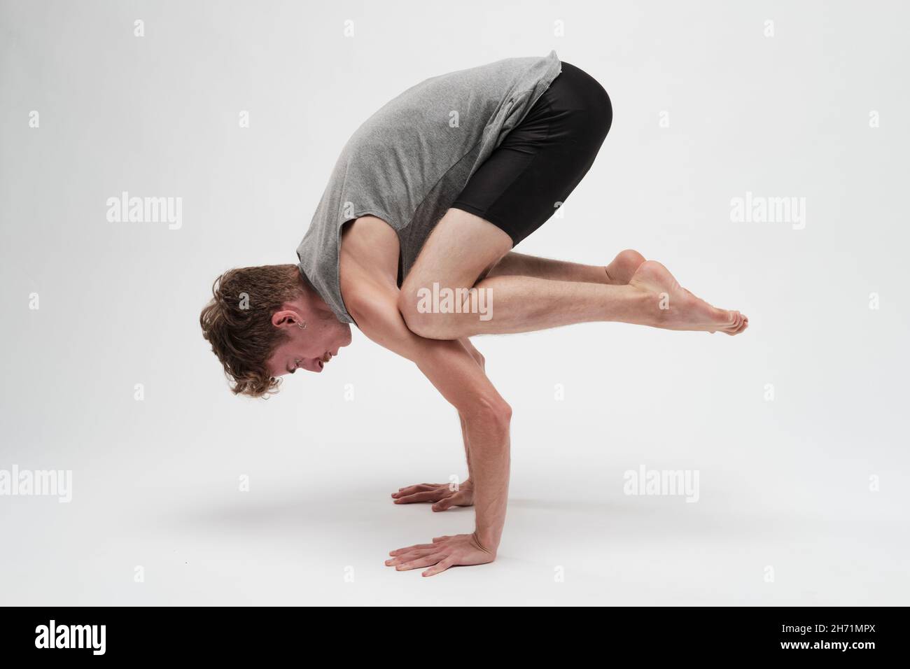 Young boy balancing on his hands on a white background Stock Photo - Alamy