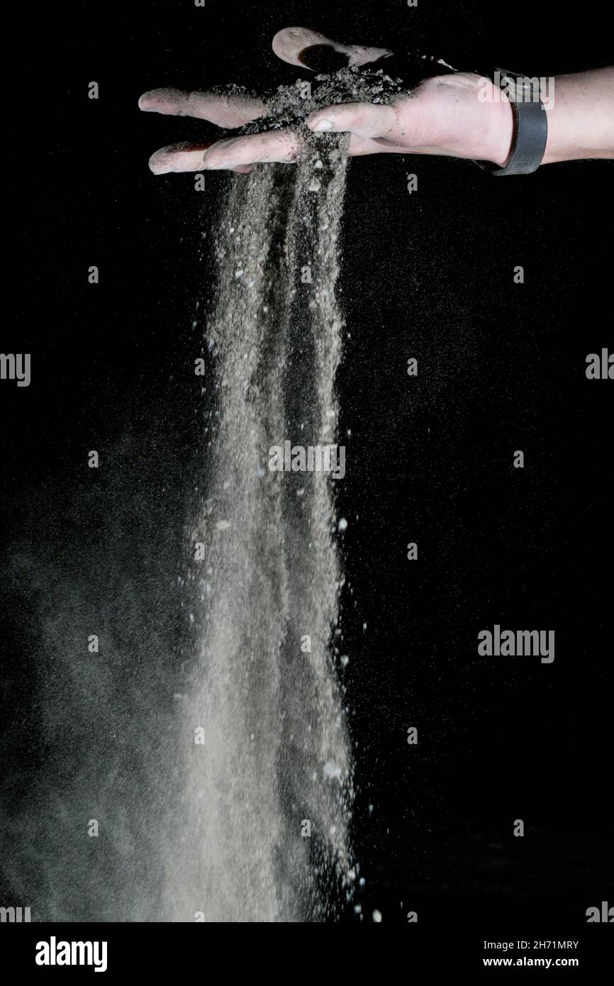 Studio shot of a man's hand with dust against black background Stock ...