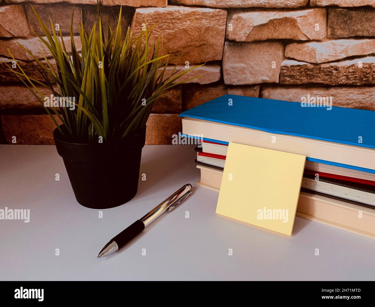 Image with sticky notes, books, pen and plant on top of a table Stock ...