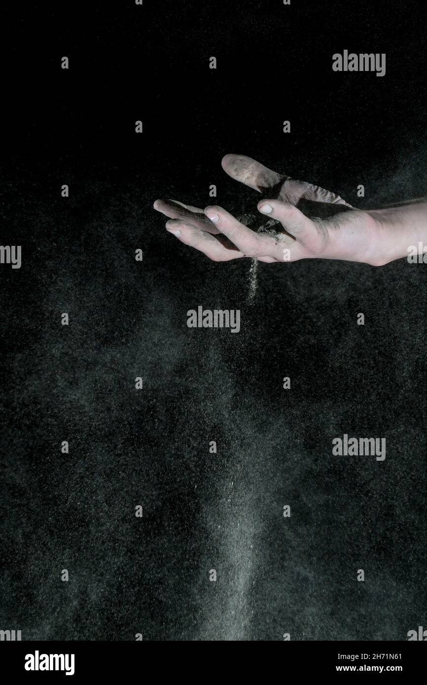 Studio shot of a man's hand with dust against black background Stock ...