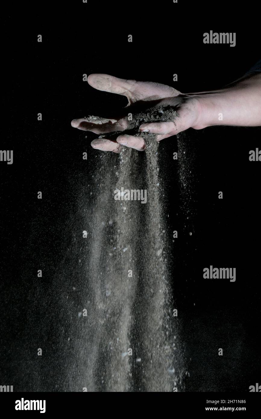 Studio shot of a man's hand with dust against black background Stock ...
