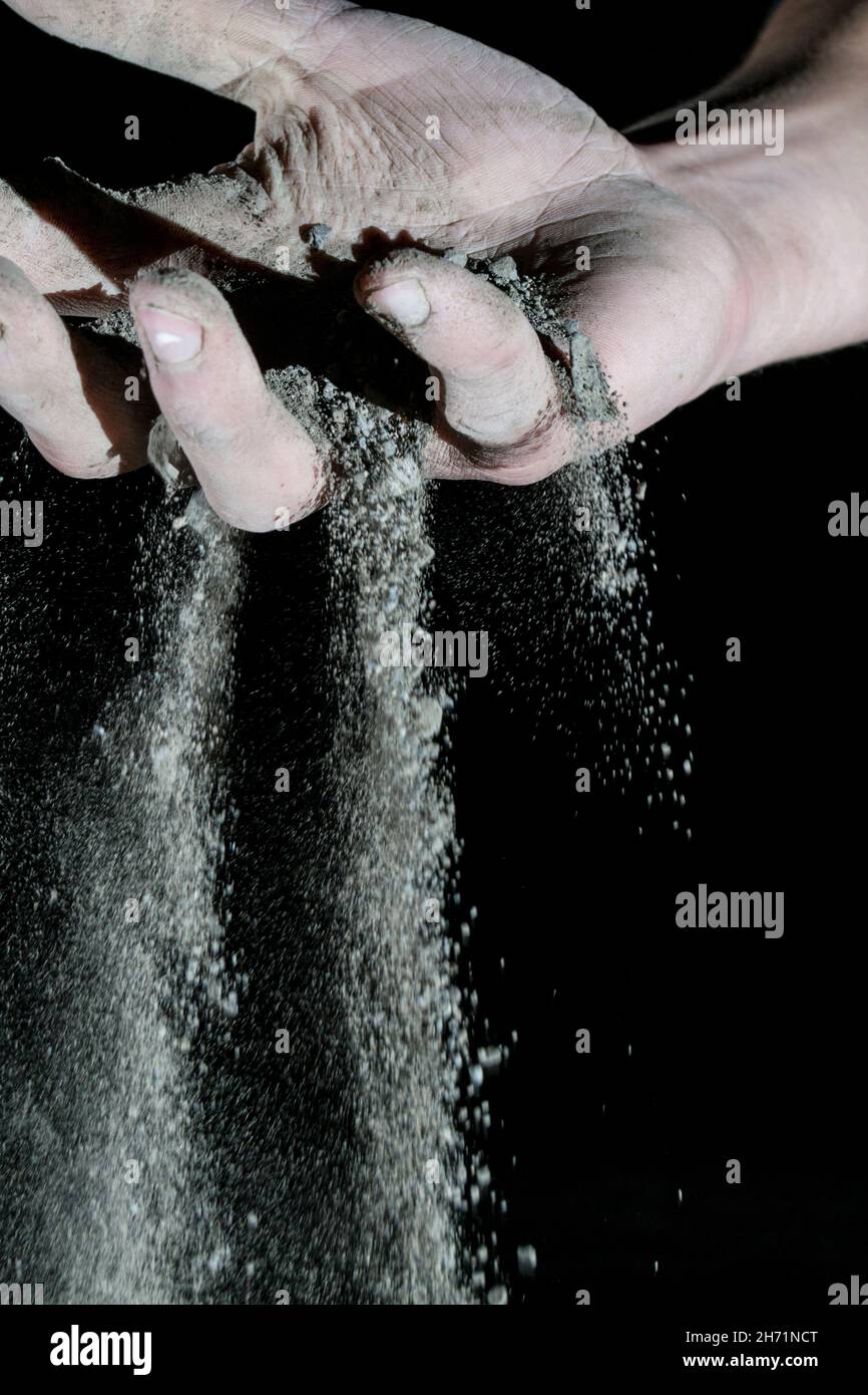 Studio shot of a man's hand with dust against black background Stock ...