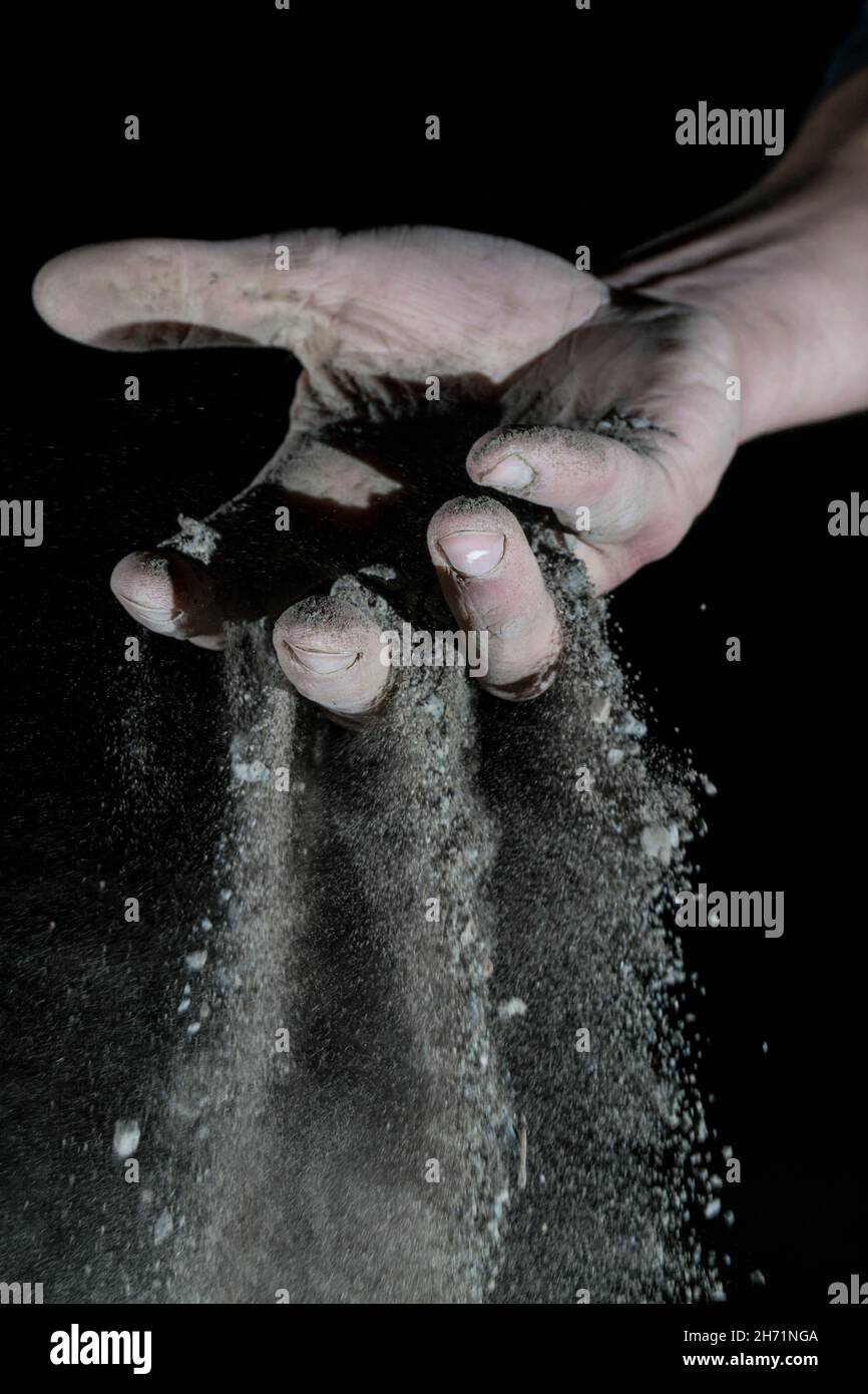 Studio shot of a man's hand with dust against black background Stock ...