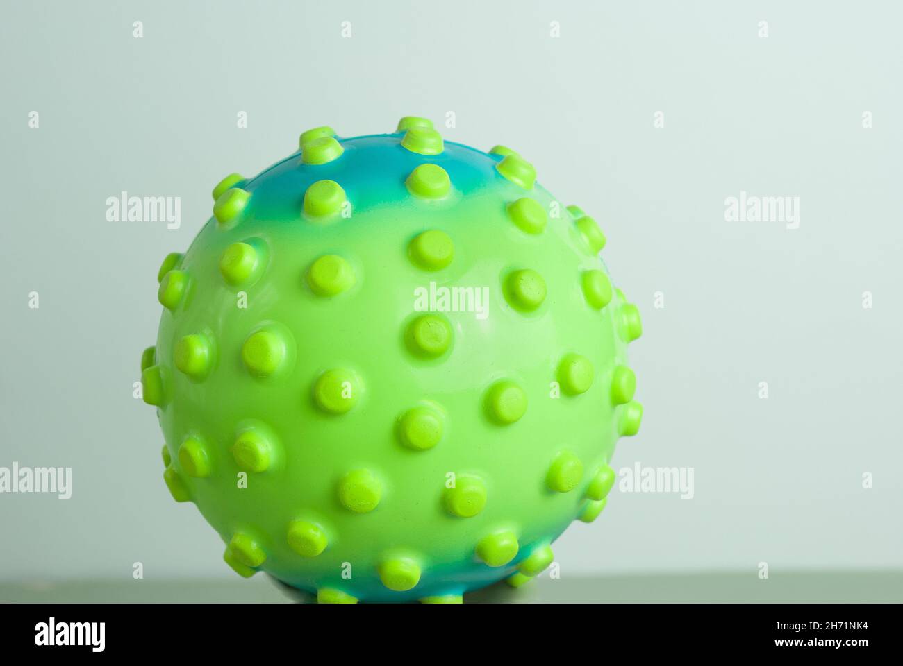 Childrens ball in the form of a virus on a gray background Stock Photo ...