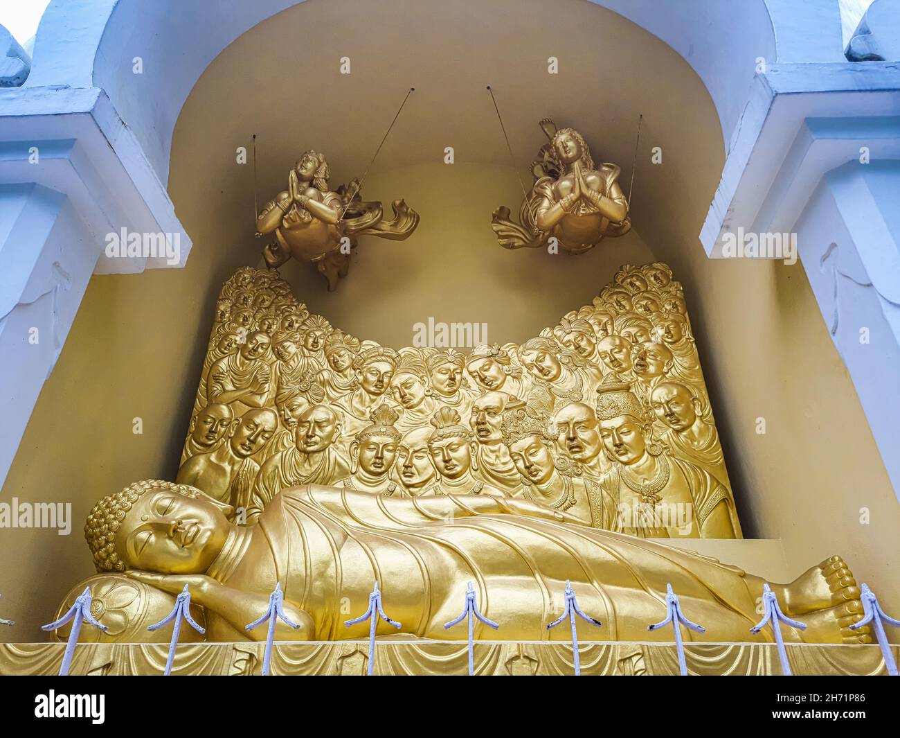 sleeping buddha golden statue from low angle at monastery at morning ...