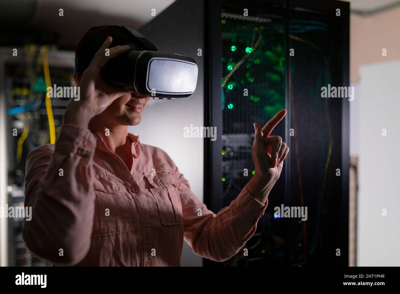 Caucasian woman wearing vr headset touching an invisible screen in ...