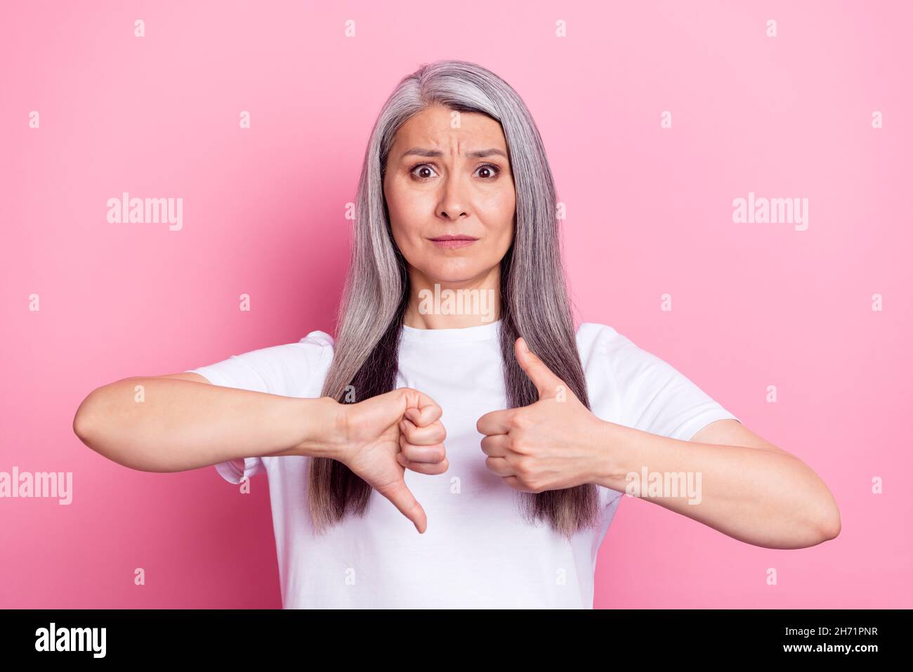 Photo portrait of aged woman showing thumb up down unsure doubt ...