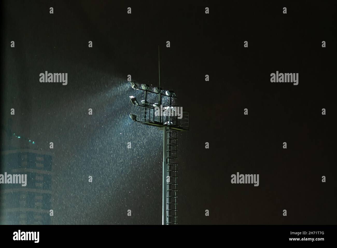 Glowing stadium spotlight at night in rainy weather, copy space Stock ...