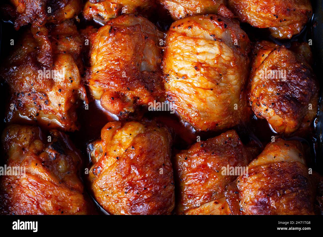 Roasted chicken thighs background. Baked chicken parts lies on flat ...
