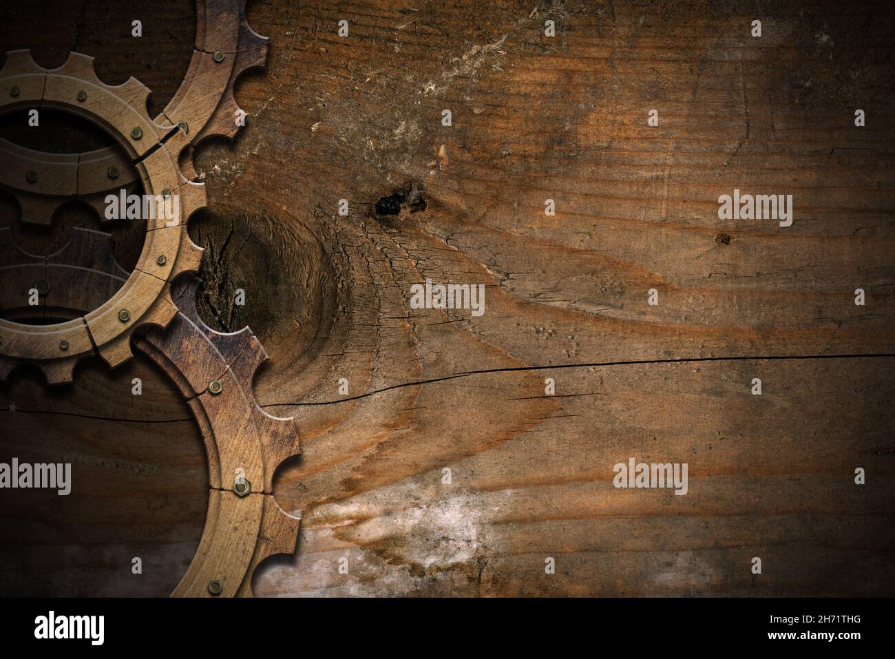 Group of three wooden cogwheels (cog wheels - gears) on a brown wooden ...