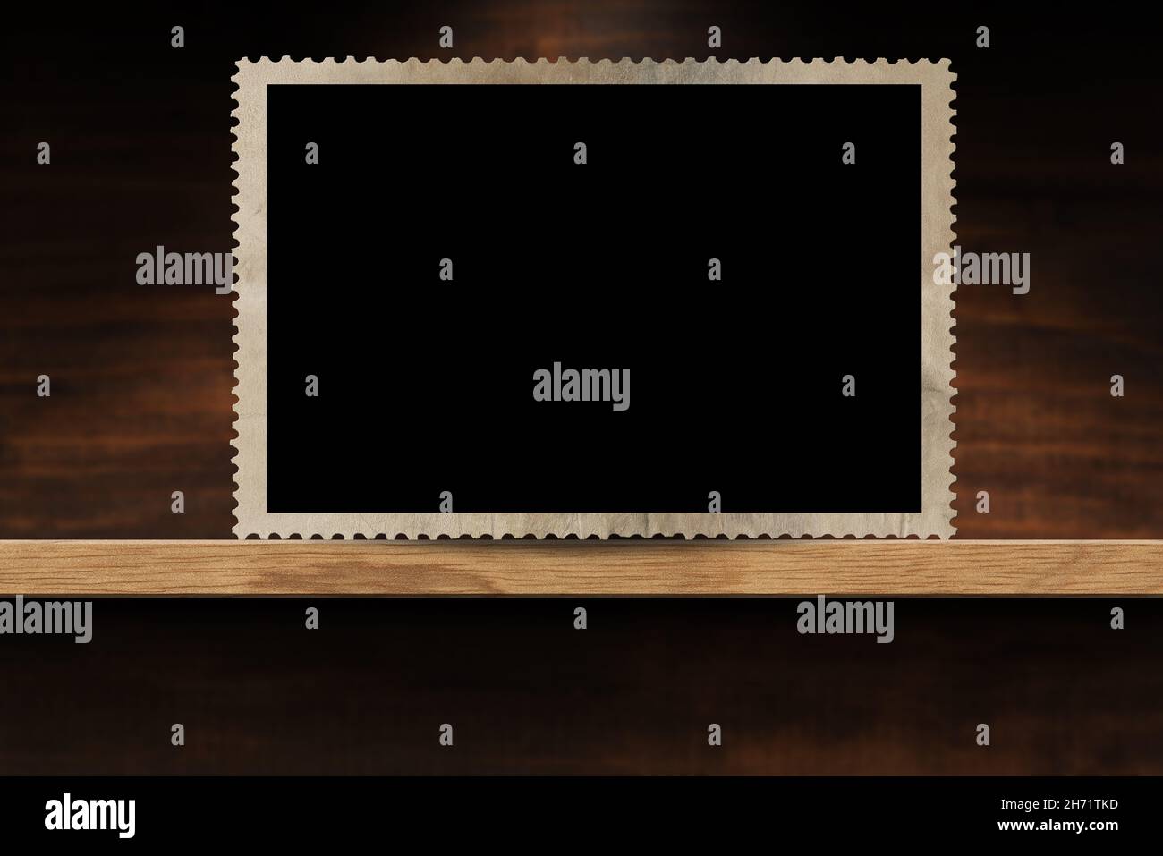 Closeup of an empty old fashioned photo frame on a wooden shelf ...