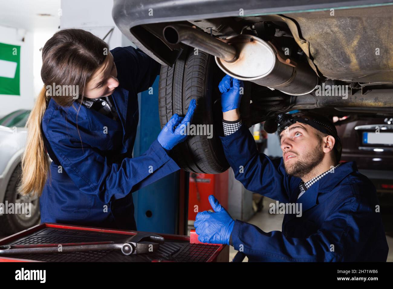 Two masters are repairing car on their workplace Stock Photo - Alamy