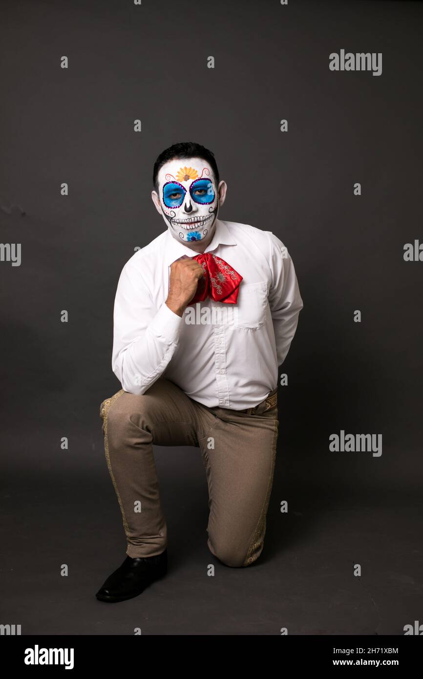 Young Hispanic male dressed up and wearing makeup for the traditional ...