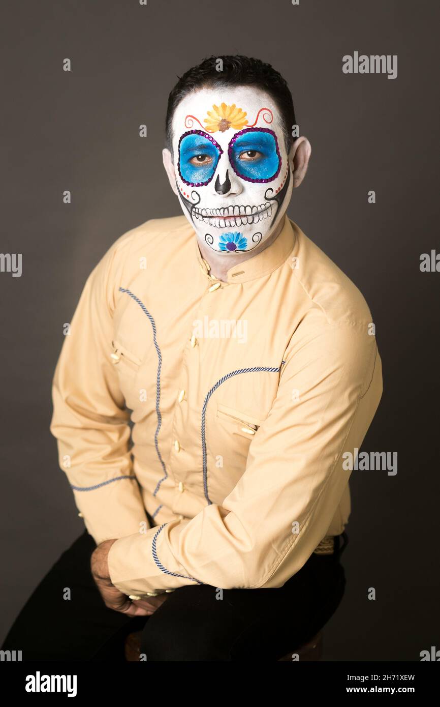 Young Hispanic male dressed up and wearing makeup for the traditional ...