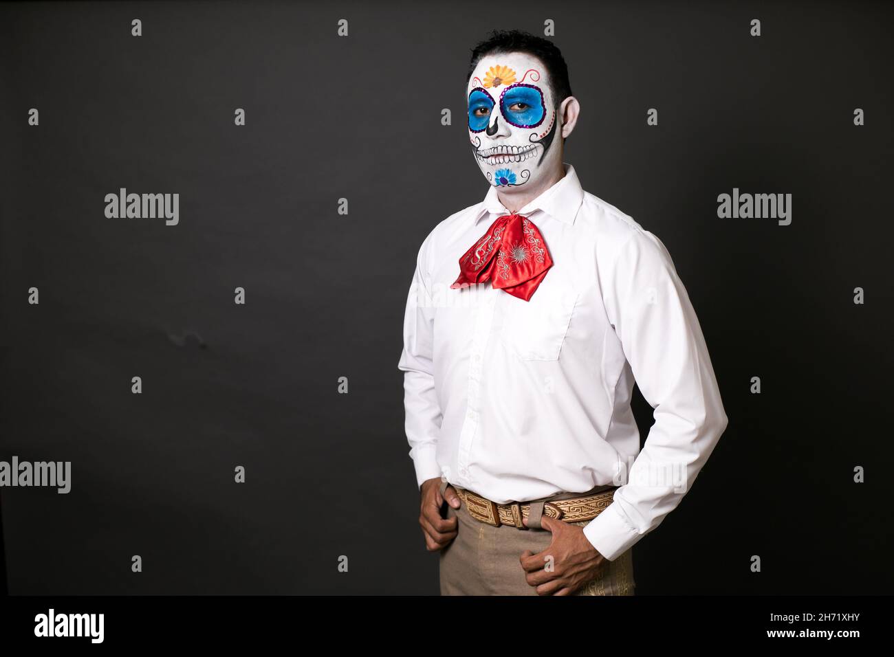 Young Hispanic male dressed up and wearing makeup for the traditional ...