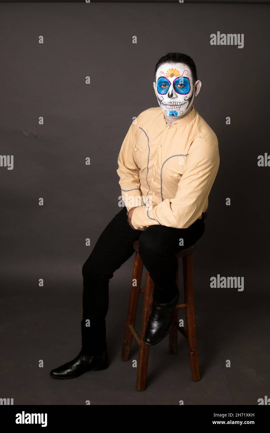 Young Hispanic male dressed up and wearing makeup for the traditional ...