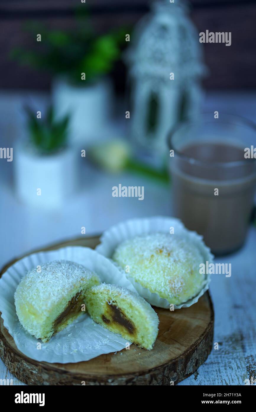 Vertical closeup shot of bread with palm sugar cream and coconut ...