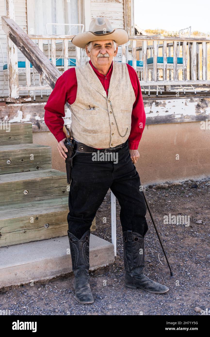 An old cowboy in period dress guides a tour through the old ghost town ...