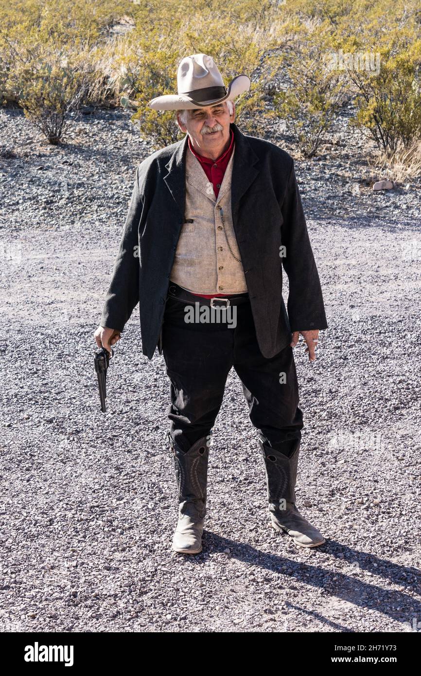 The cowboy guide with his old black powder six-shooter in the old ghost ...