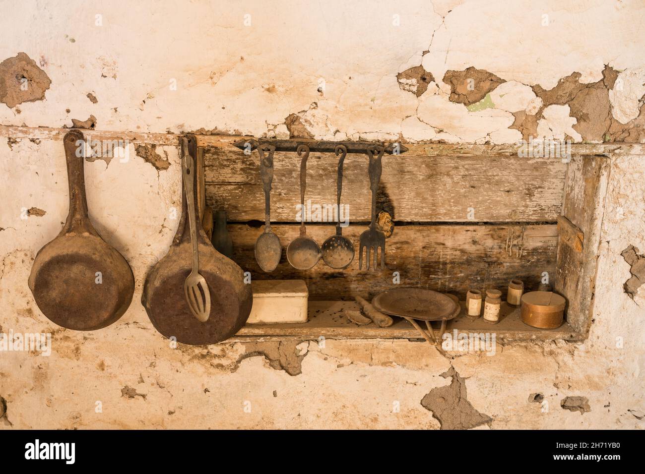 Cast iron skillets and cooking utensils in the kitchen of the old ...