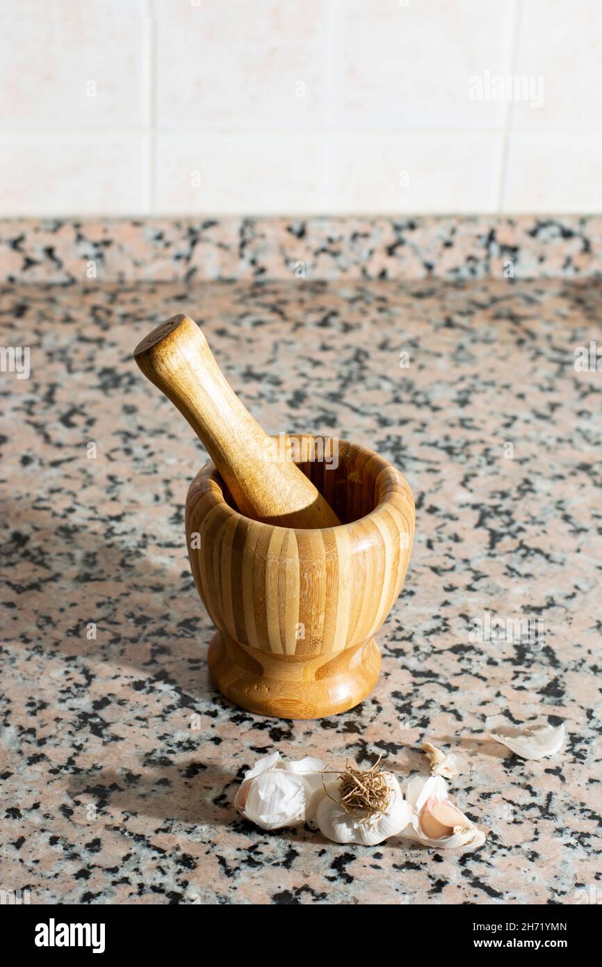 Wooden Mortar Pestle. Garlic on the blue baclground Stock Photo - Alamy