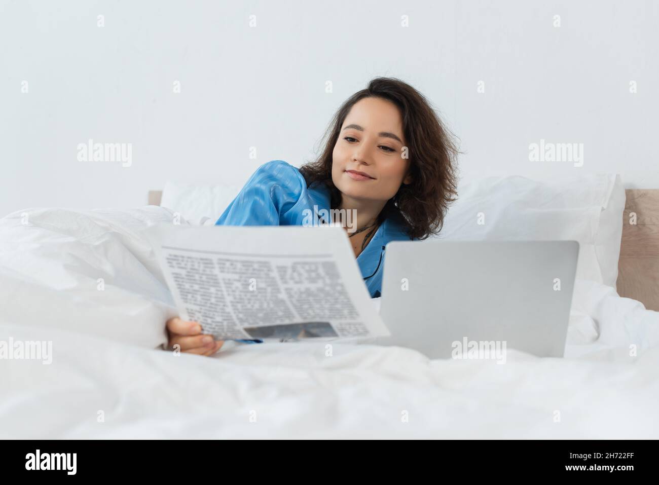 Woman reading newspaper on computer hi-res stock photography and images ...