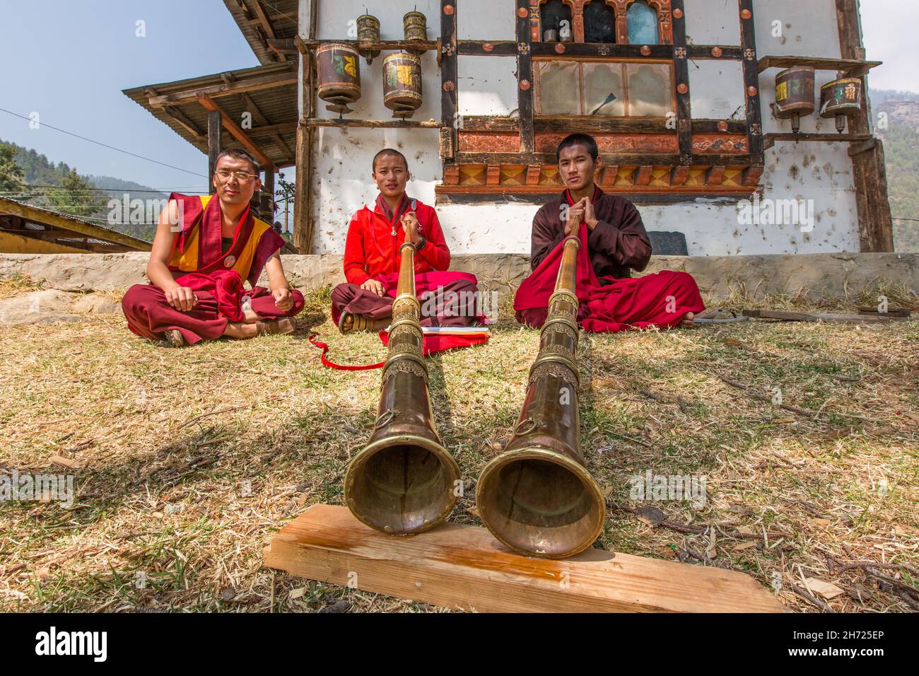 Young Buddhist monks practicing the Tibetan dungchen horn at the Dechen ...