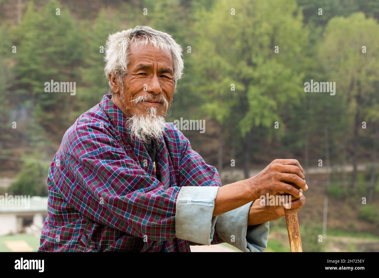 An older Bhutanese man in the traditional gho robe in Thimphu, Bhutan ...