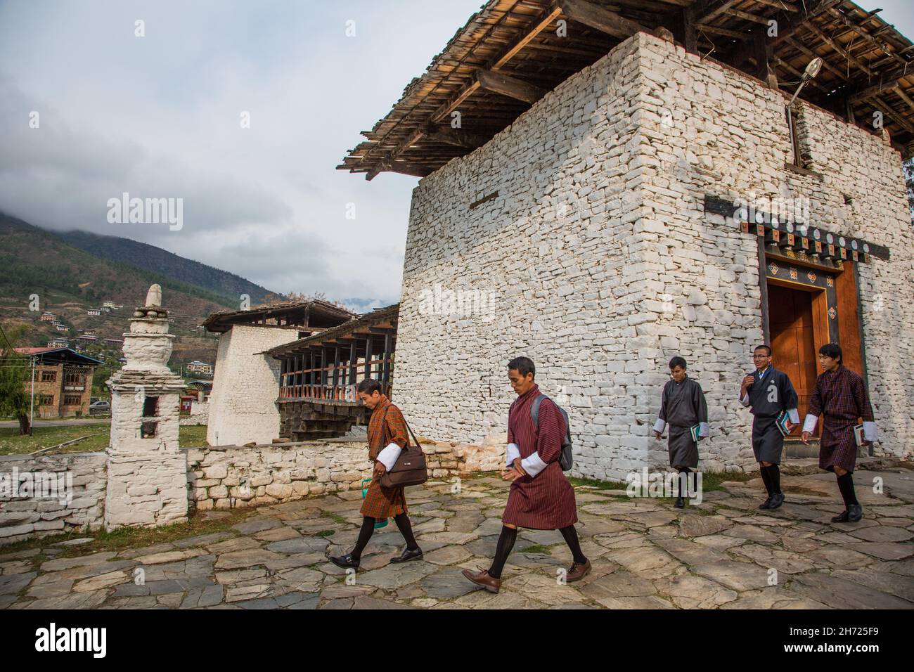 A group of students walking to school past the bazam or covered bridge ...