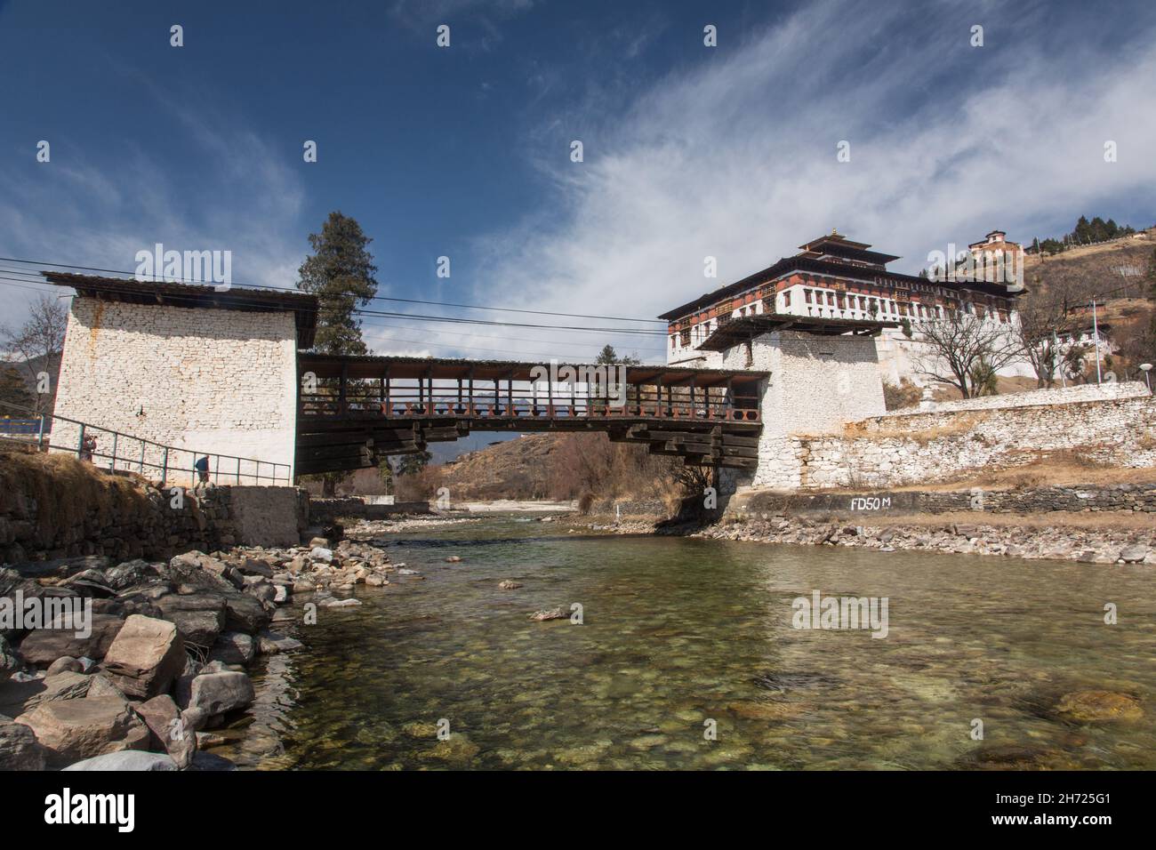 The Rinchen Pung Dzong with its bazam bridge over the Paro River and ...