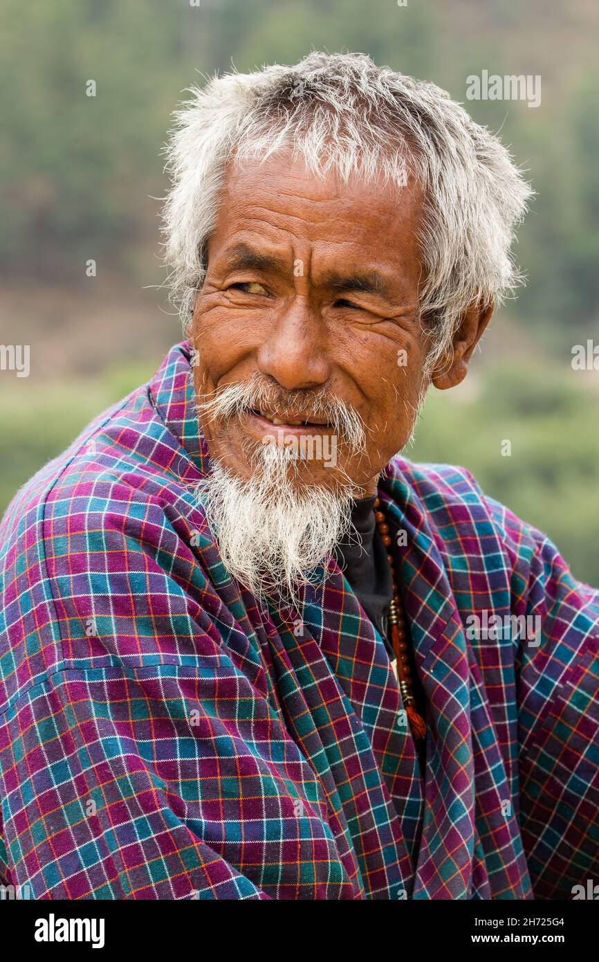 An older Bhutanese man in the traditional gho robe in Thimphu, Bhutan ...