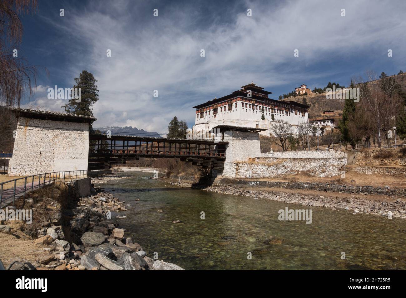 The Rinchen Pung Dzong with its bazam bridge over the Paro River and ...