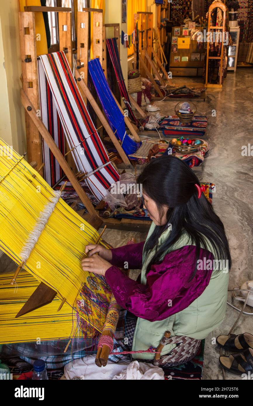 A Bhutanese woman weaving fabric on a wooden loom by hand in Bhutan Stock Photo - Alamy