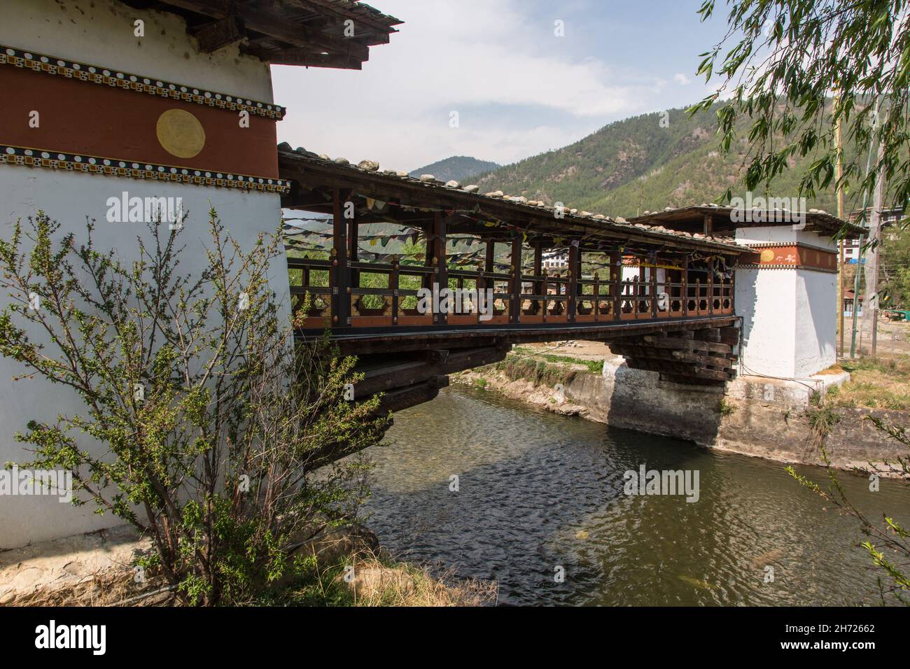 A bazam or cantilevered covered wooden bridge over the Thimphu or Wang ...